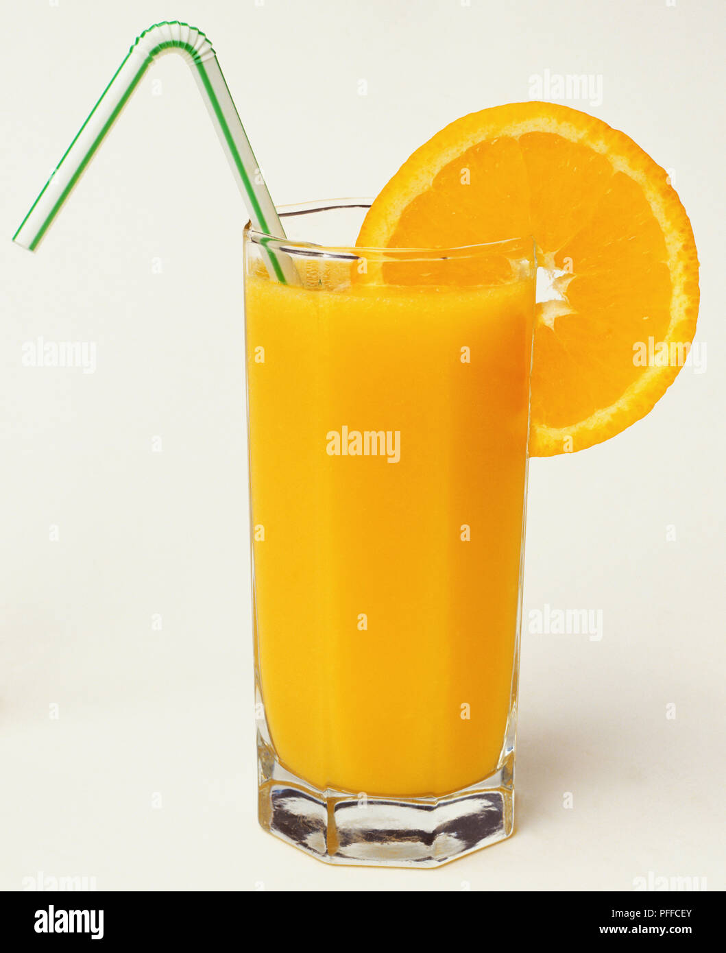 Tall glass of orange juice with straw and segment of orange Stock Photo ...
