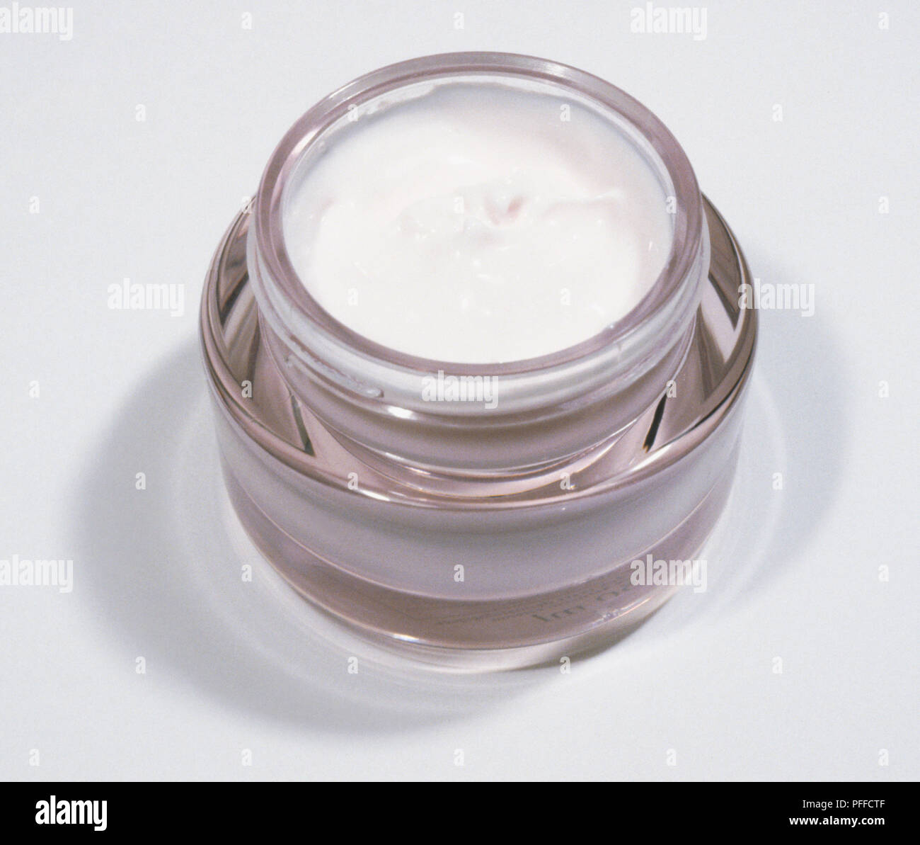 Glass pot of cosmetic cream with lid removed, elevated view Stock Photo ...