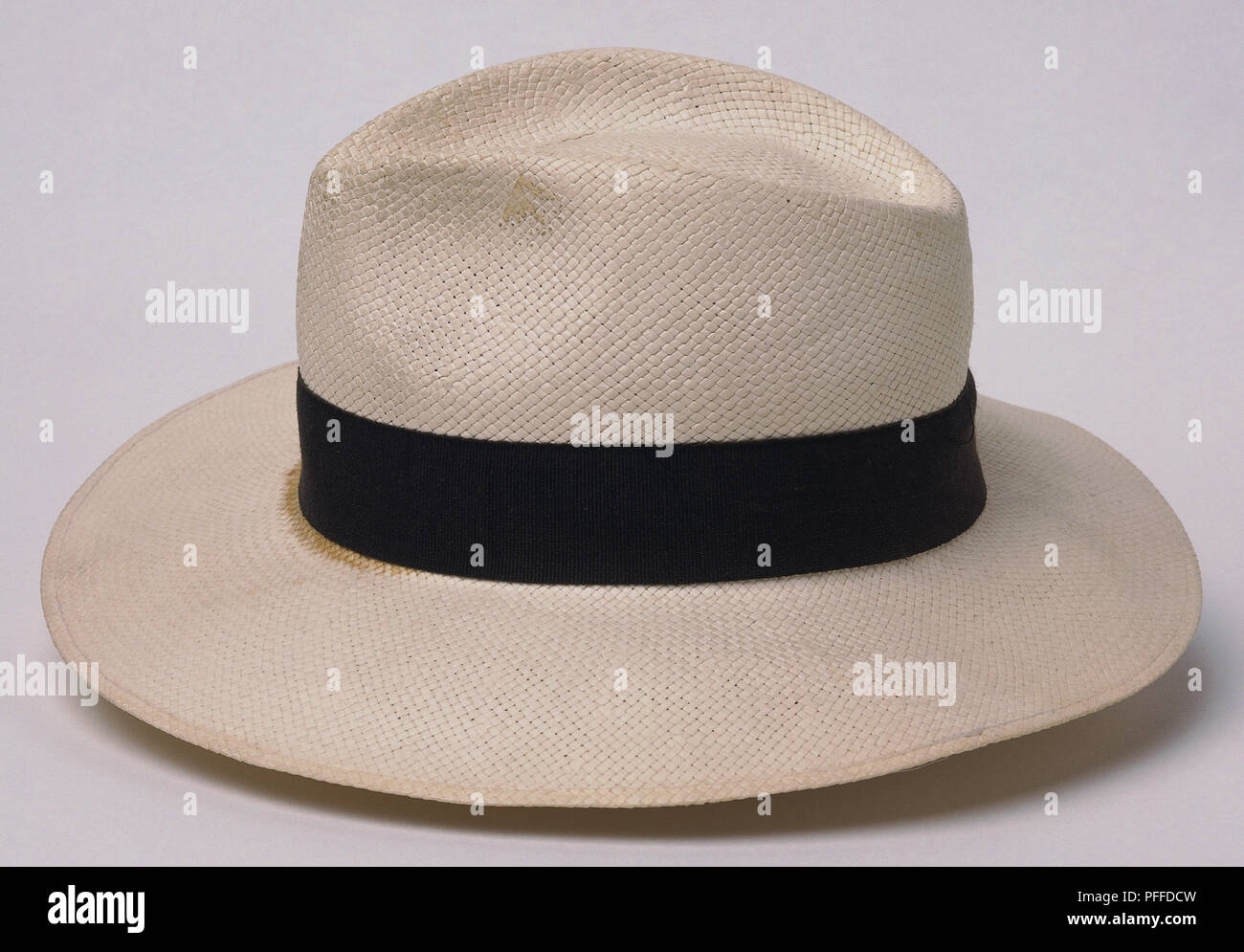 Cream panama hat with black band around the rim Stock Photo - Alamy