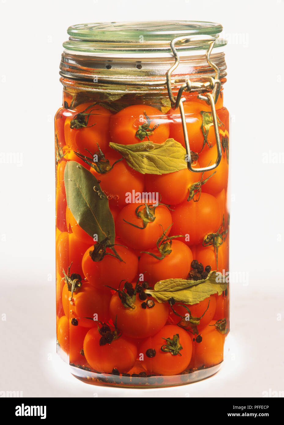 Glass jar of preserved red cherry tomatoes Stock Photo - Alamy