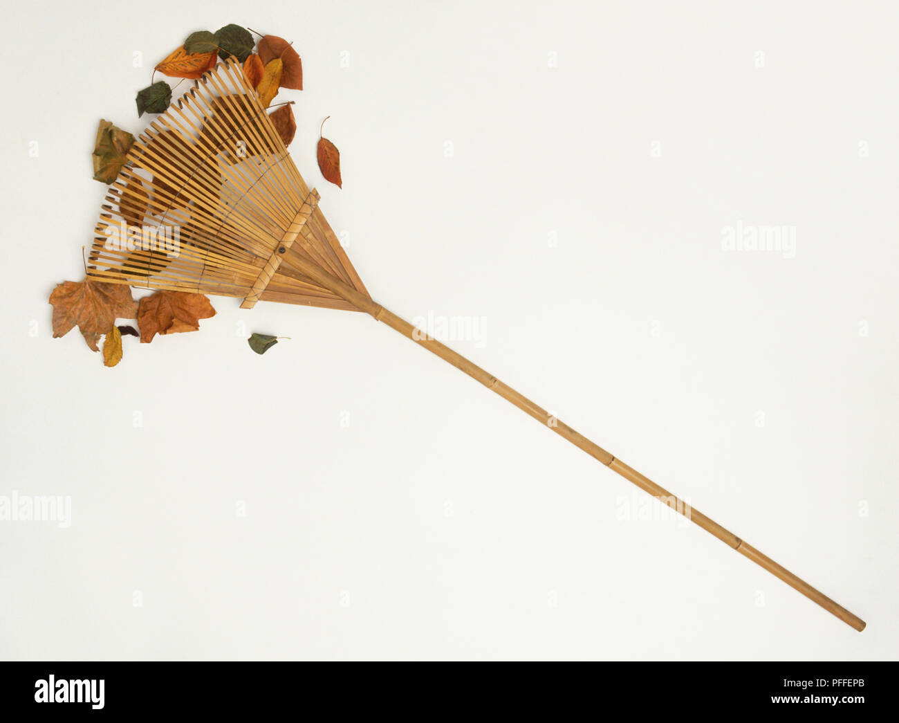 Bamboo leaf rake and autumn leaves Stock Photo - Alamy
