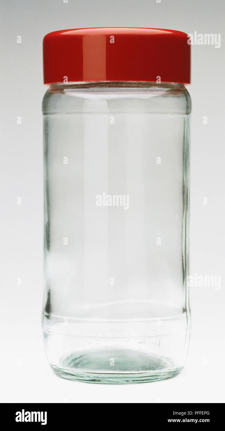 An empty clear glass jar with a red lid on Stock Photo - Alamy