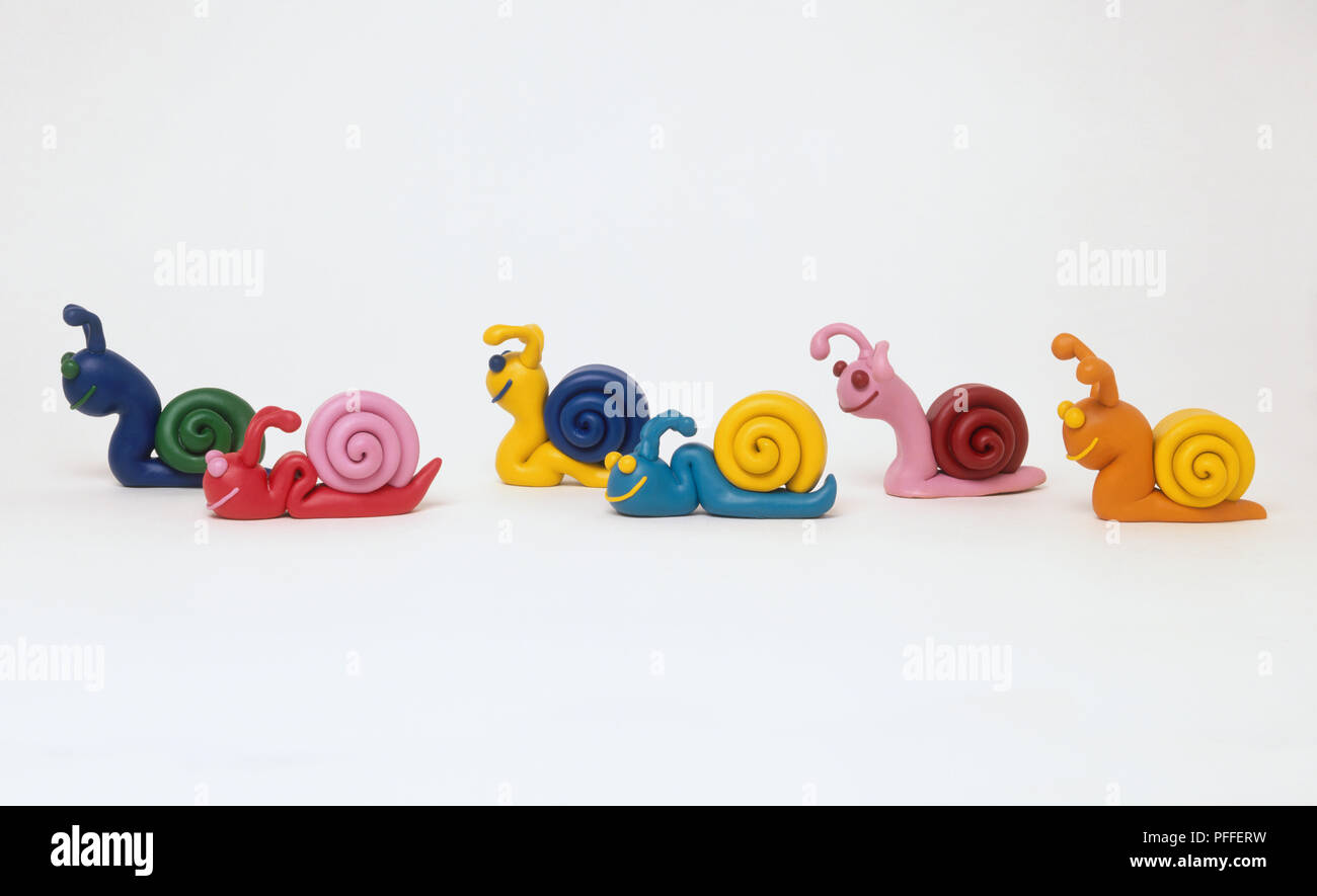 Six multi-coloured snails made out of play clay Stock Photo - Alamy