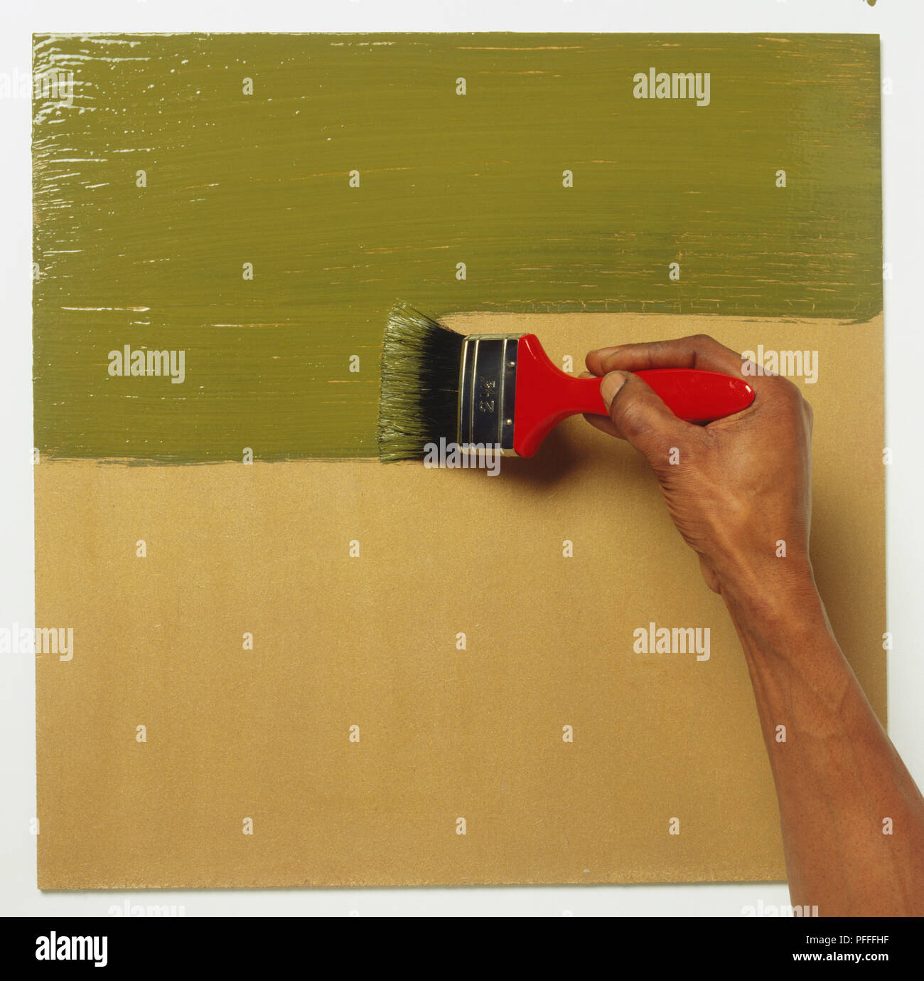 Person painting piece of wood Stock Photo - Alamy