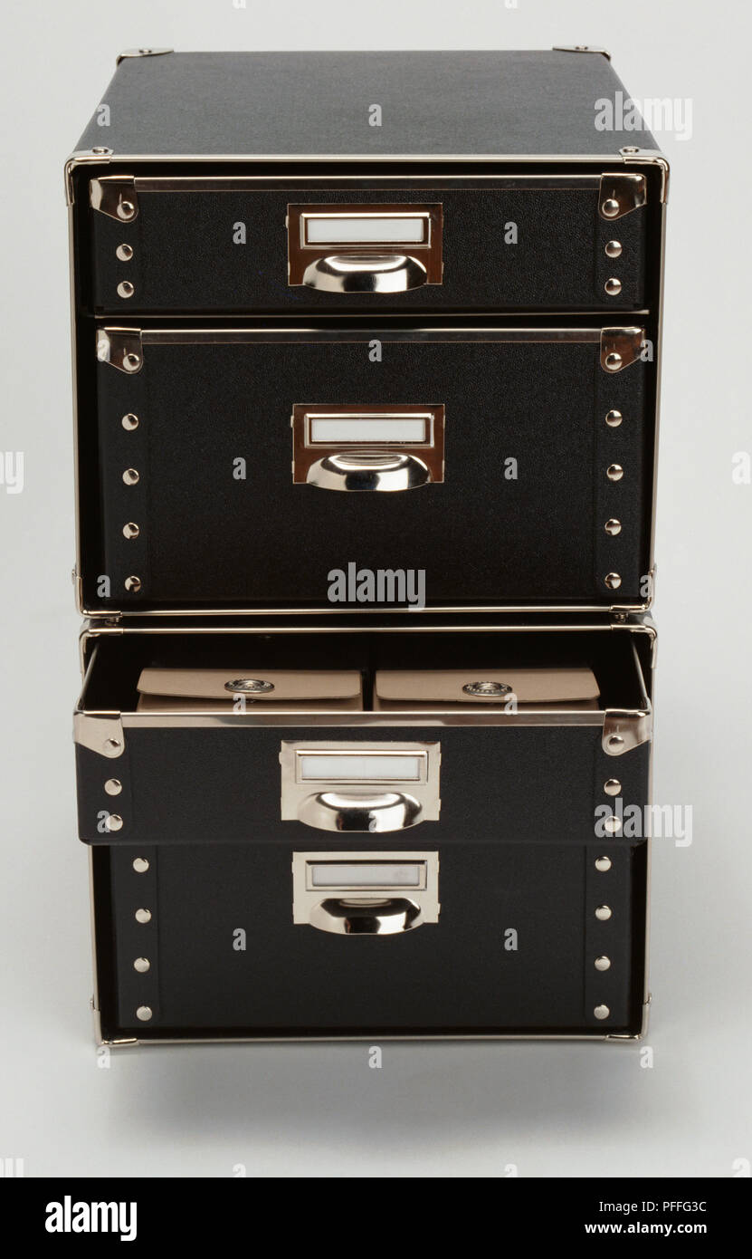 Black fibreboard storage box with four drawers one open Stock Photo - Alamy