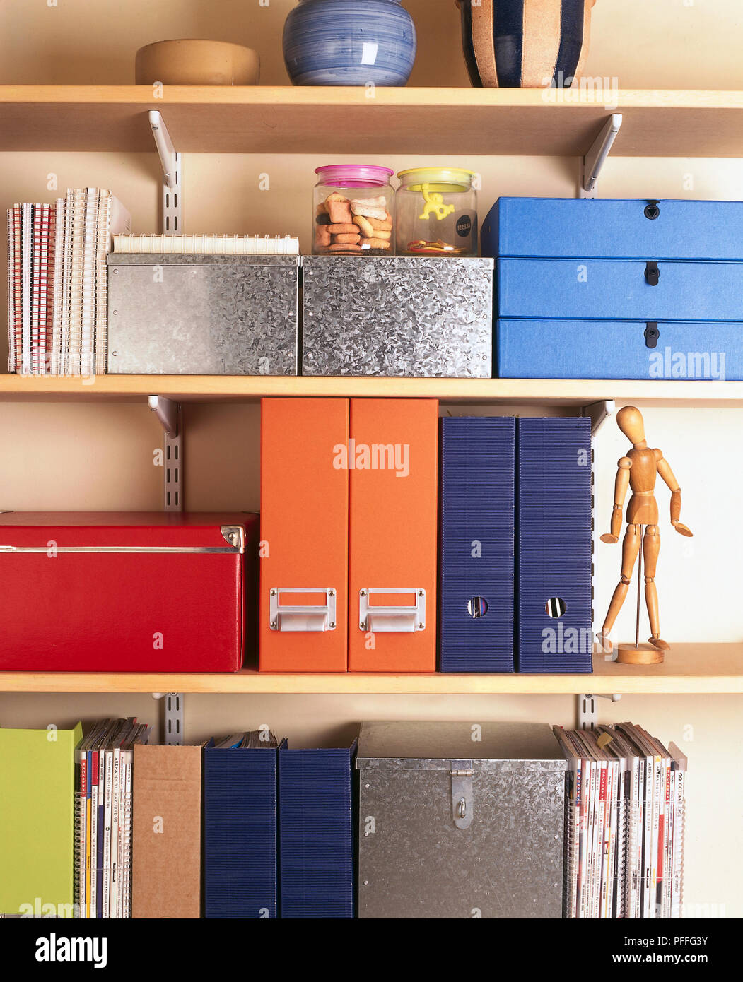 Wooden shelves with a variety of storage solutions including glass jars ...