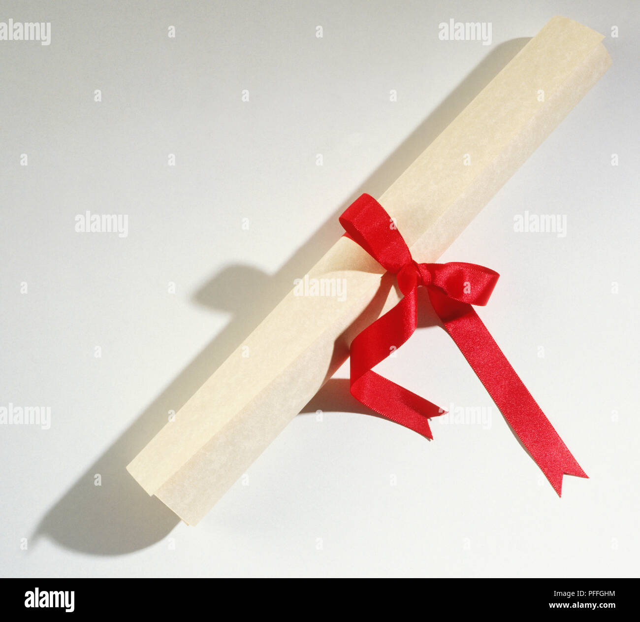 Piece of paper rolled and tied with ribbon Stock Photo - Alamy