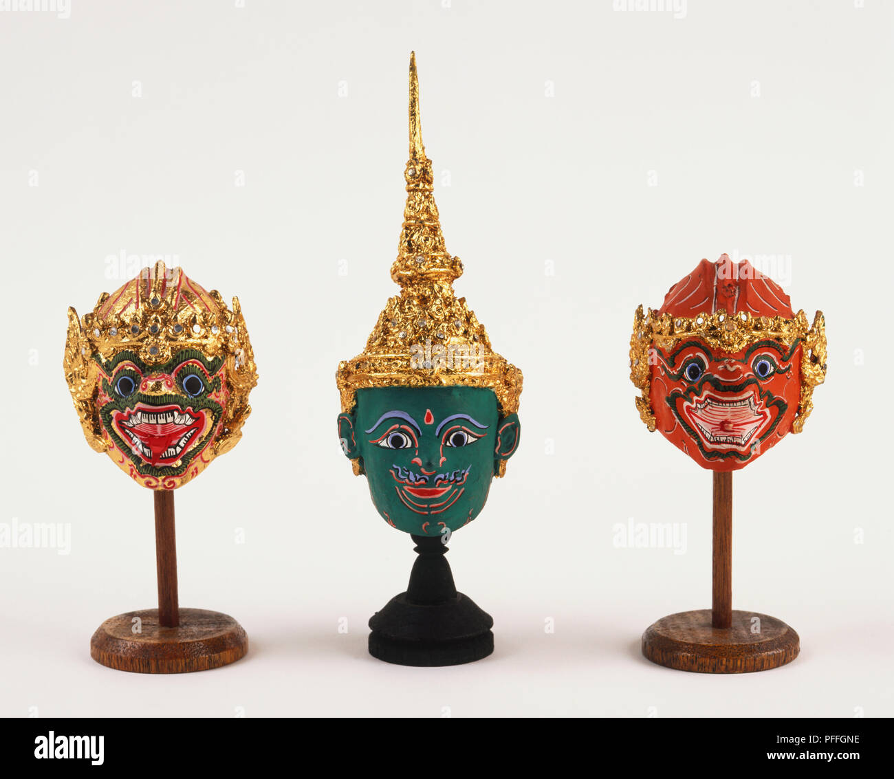 Thailand, three painted demon masks on wooden stands, front view Stock ...