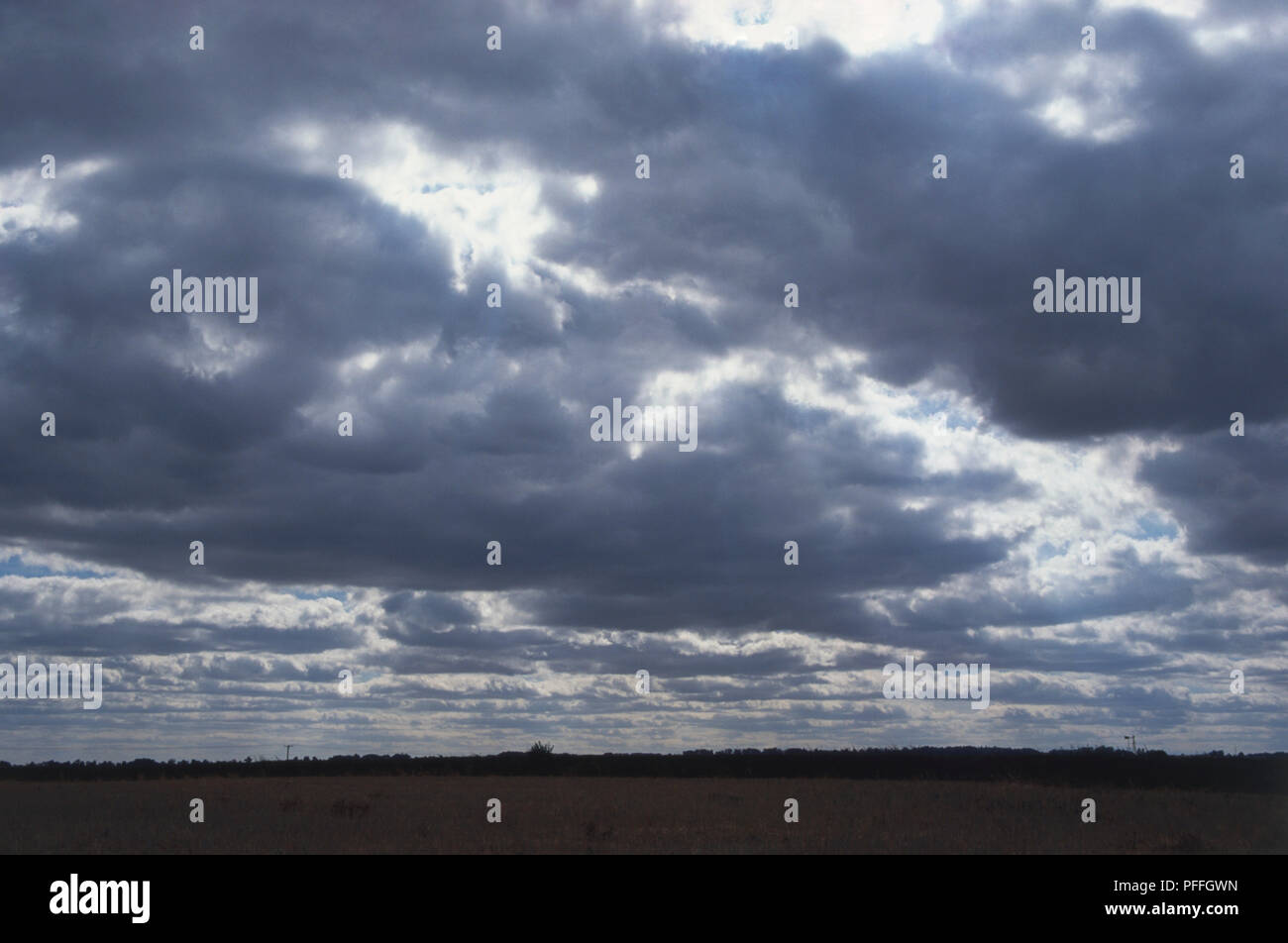 Stratocumulus, high clouds characterised by large dark, rounded masses ...