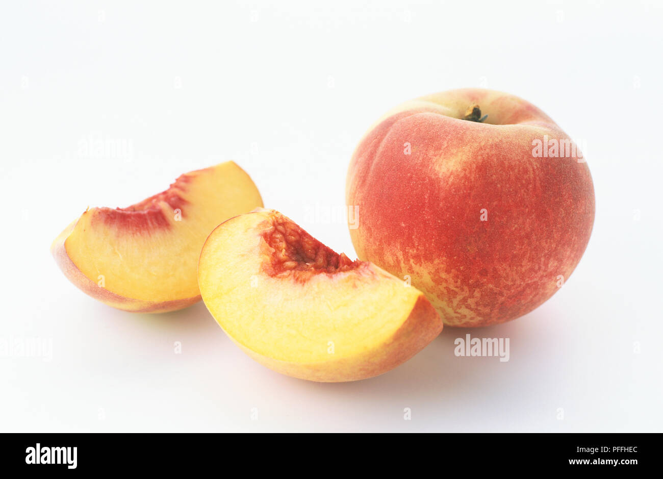 Whole fresh peach and two slices Stock Photo - Alamy