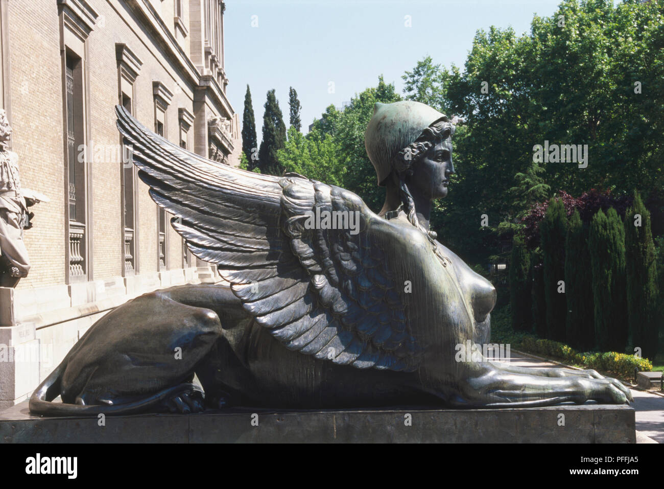 Spain, Madrid, side view of a winged statue at the entrance to the ...