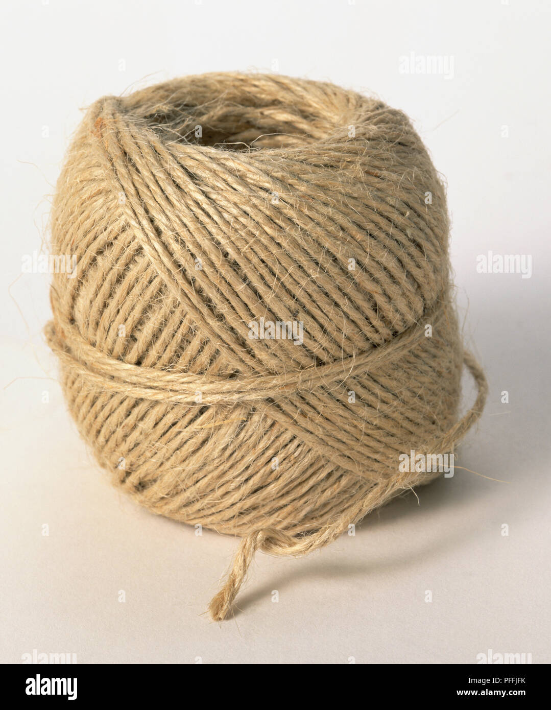 Ball of string, beige coloured fibres, angled side view Stock Photo - Alamy