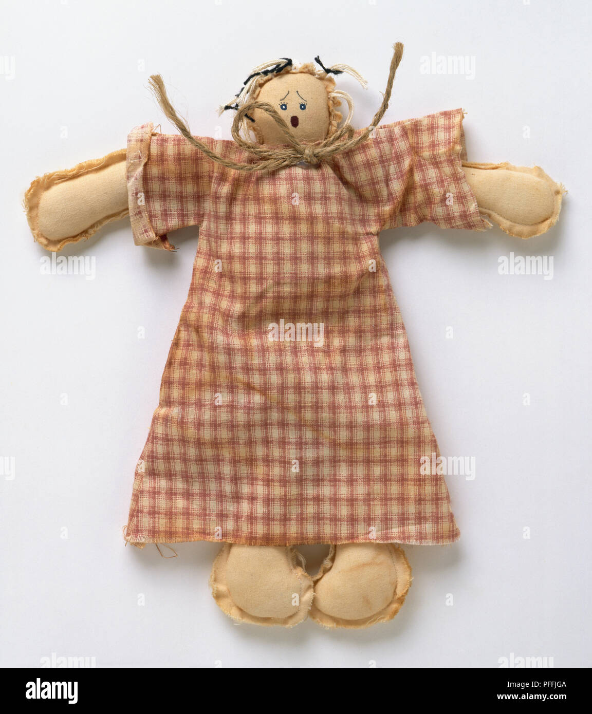Rag doll, made from fabric and wool, wearing red and white checked ...