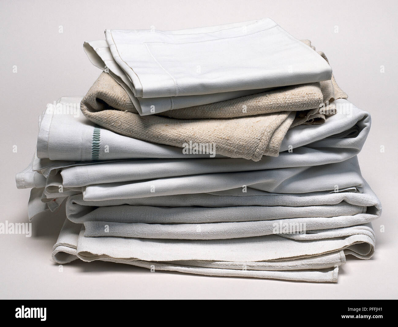 Pile of folded worn and washed linen Stock Photo - Alamy