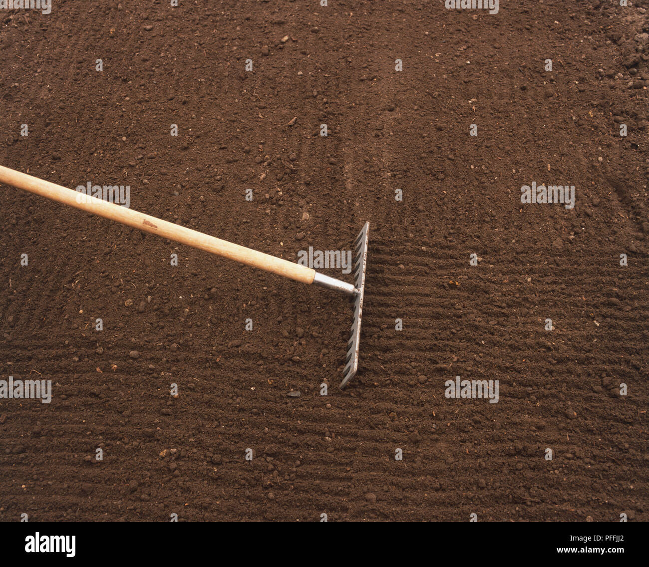 Soil being raked Stock Photo - Alamy