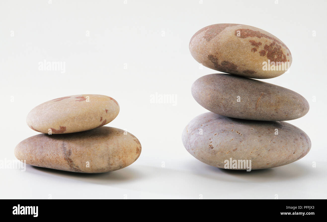 Three pebbles on top of each other Stock Photo - Alamy
