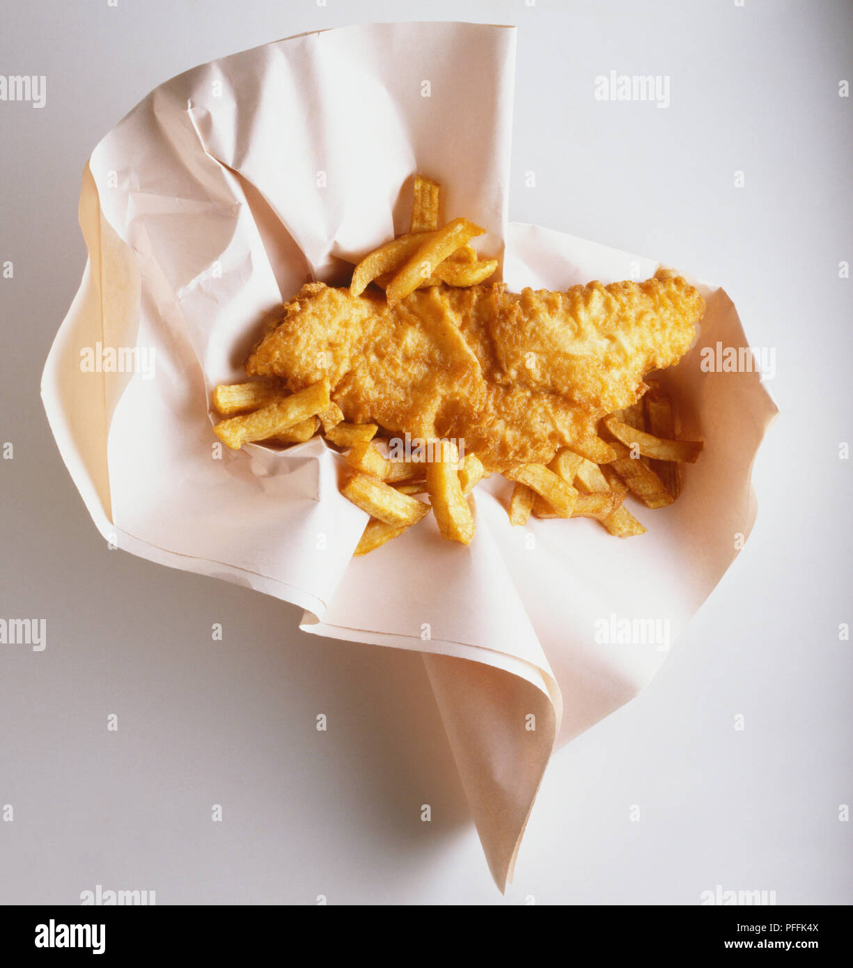 Fish and chips in paper wrapping Stock Photo - Alamy
