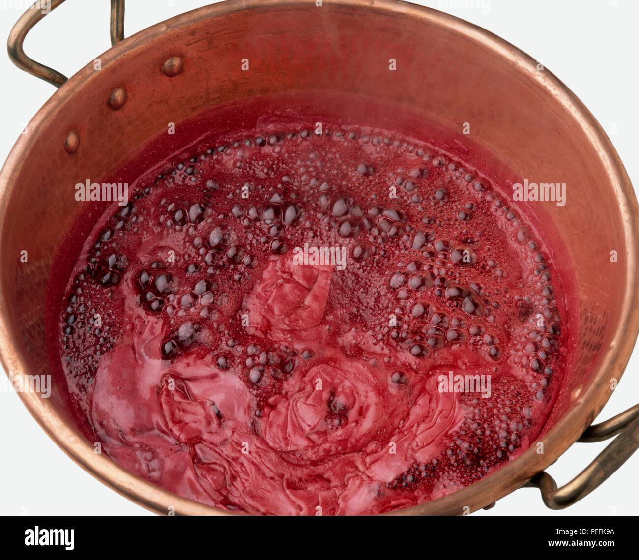 Raspberry jelly boiling in Pan Stock Photo - Alamy