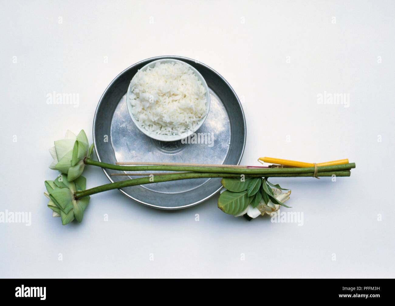 Buddhist alms bowl containing rice, lotus flowers, incense sticks Stock ...