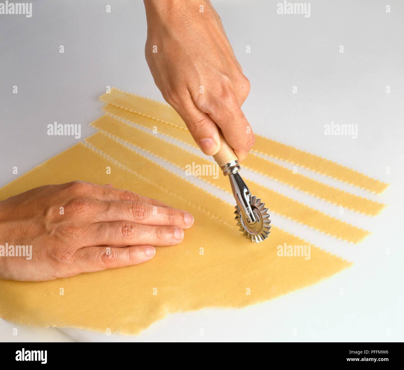 Person cutting dough strips hi-res stock photography and images - Alamy