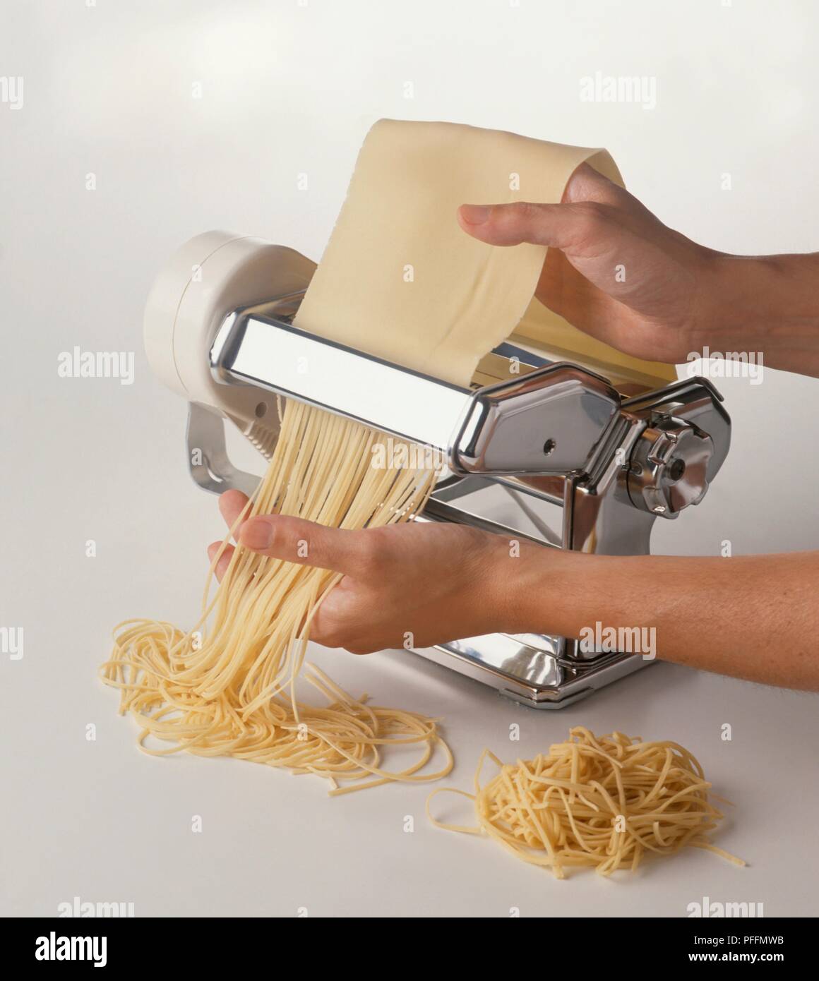 Cutting pasta by machine Stock Photo - Alamy