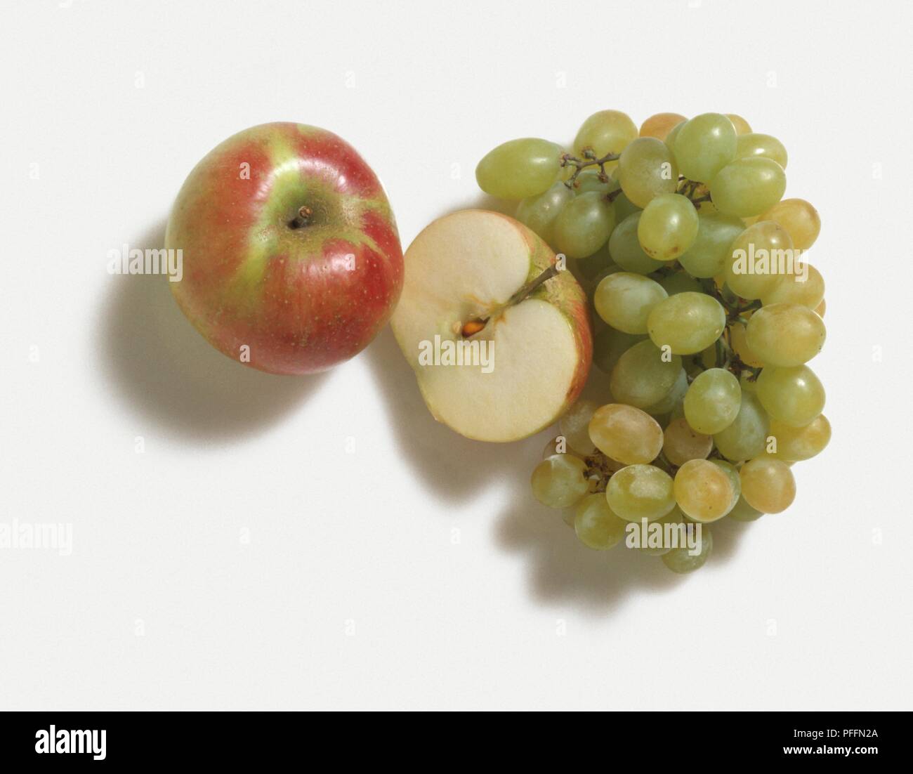 Bunch of white grapes, apple and half apple Stock Photo - Alamy