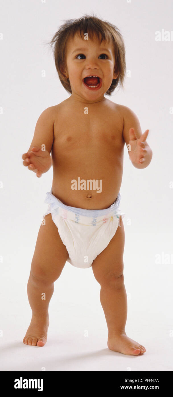 Toddler wearing nappy, walking forward, laughing, looking happy, front ...