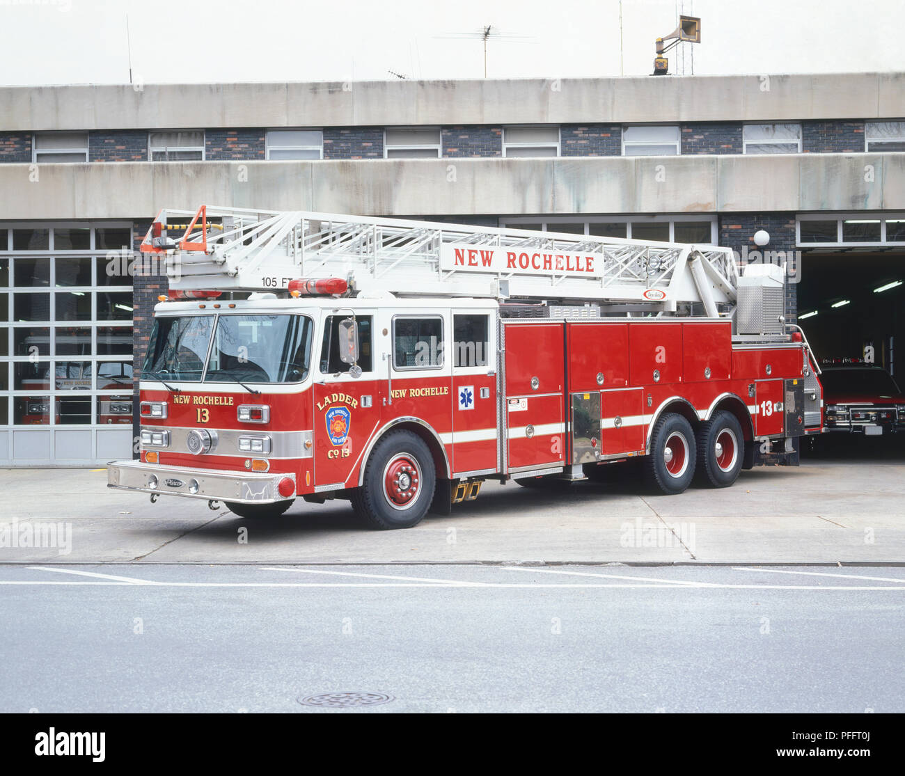 A red fire engine with a white ladder on the roof Stock Photo - Alamy