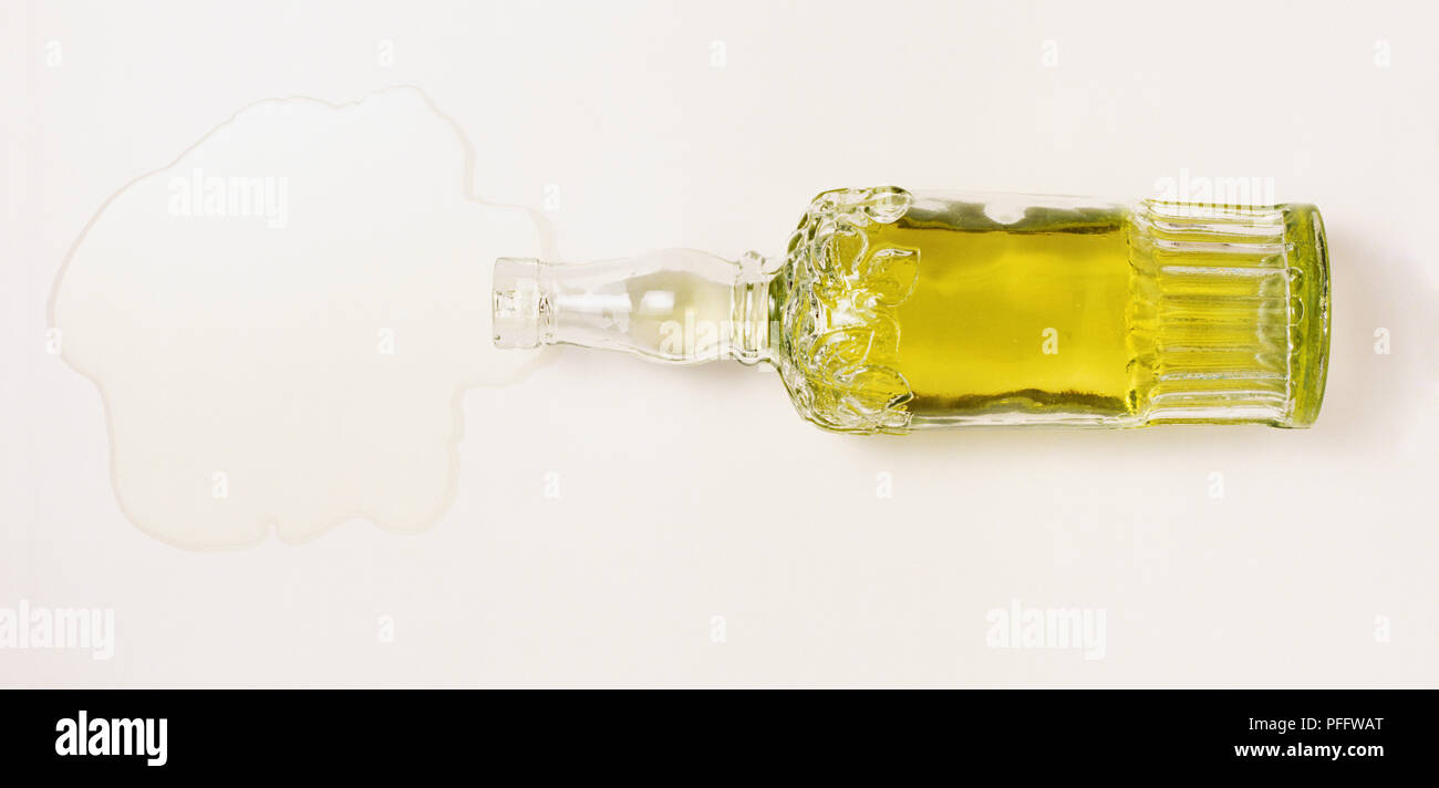 Bottle with vegetable oil spilling out of it Stock Photo - Alamy