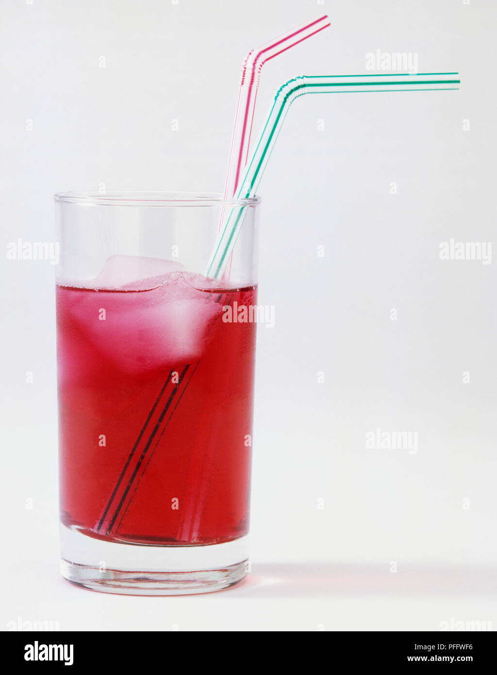 Glass of Raspberry cordial with ice and two straws Stock Photo - Alamy