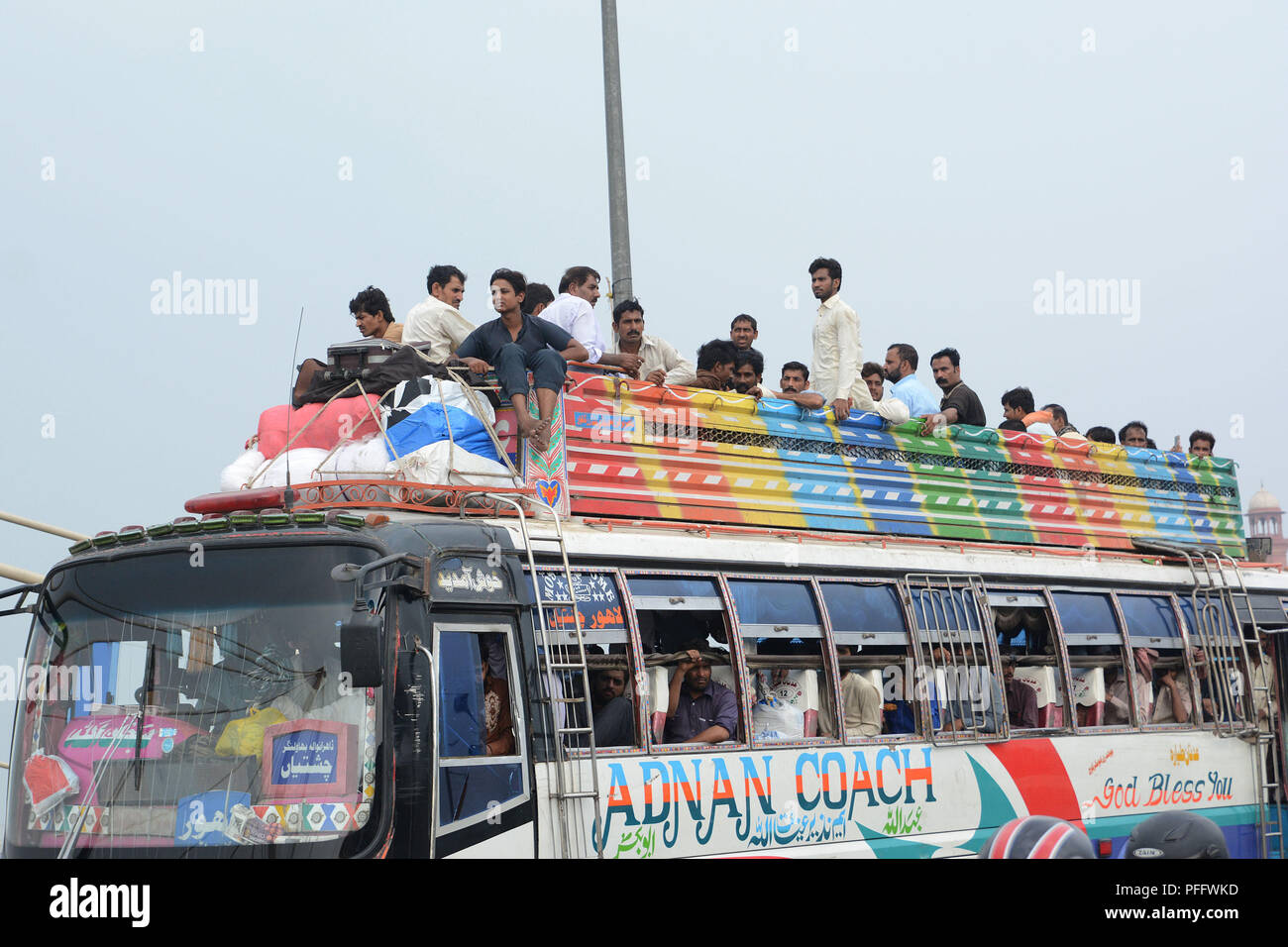 Pakistani passengers travel on a overcrowded bus to reach their ...