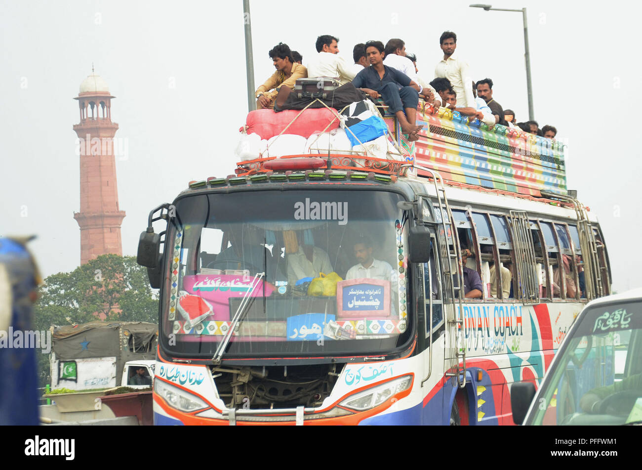 Pakistani passengers travel on a overcrowded bus to reach their ...