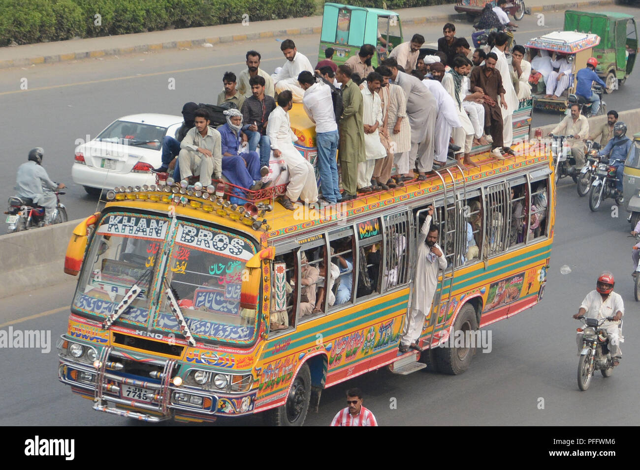 Pakistani passengers travel on a overcrowded bus to reach their ...