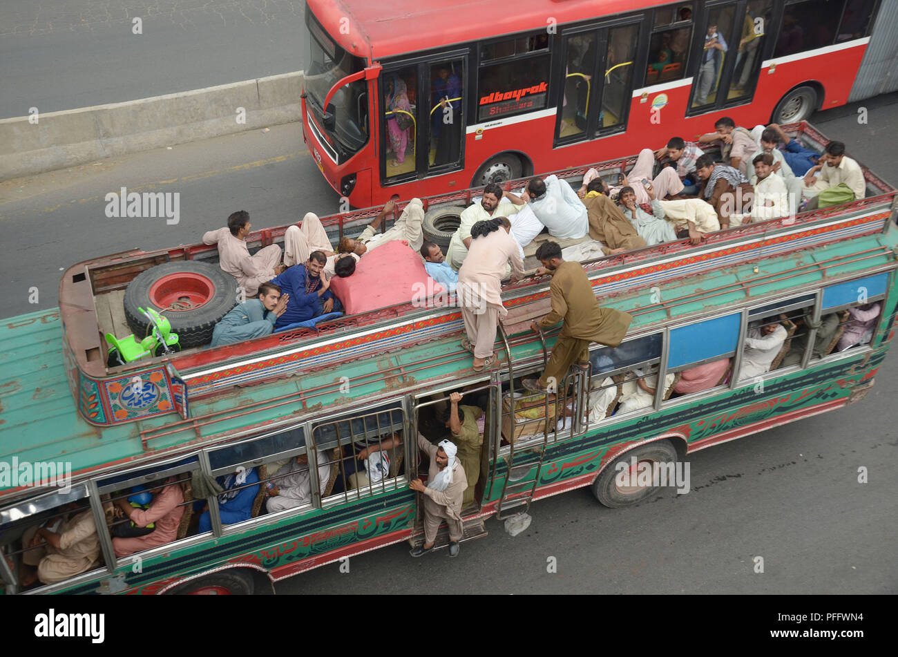 Pakistani passengers travel on a overcrowded bus to reach their ...