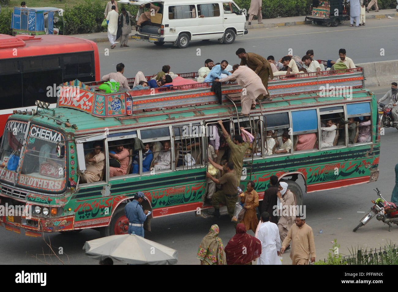 Pakistani passengers travel on a overcrowded bus to reach their ...