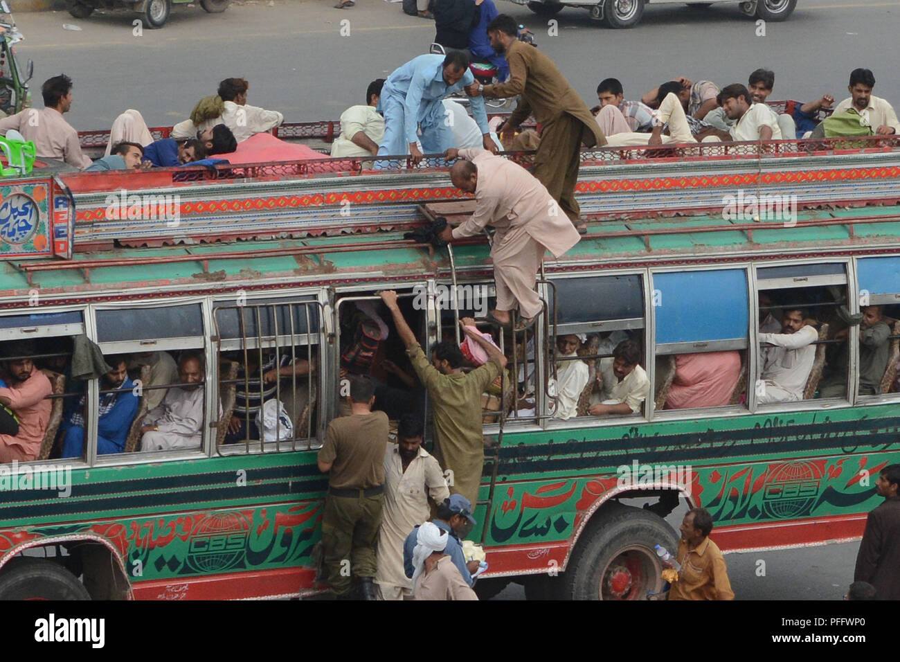 Pakistani passengers travel on a overcrowded bus to reach their ...