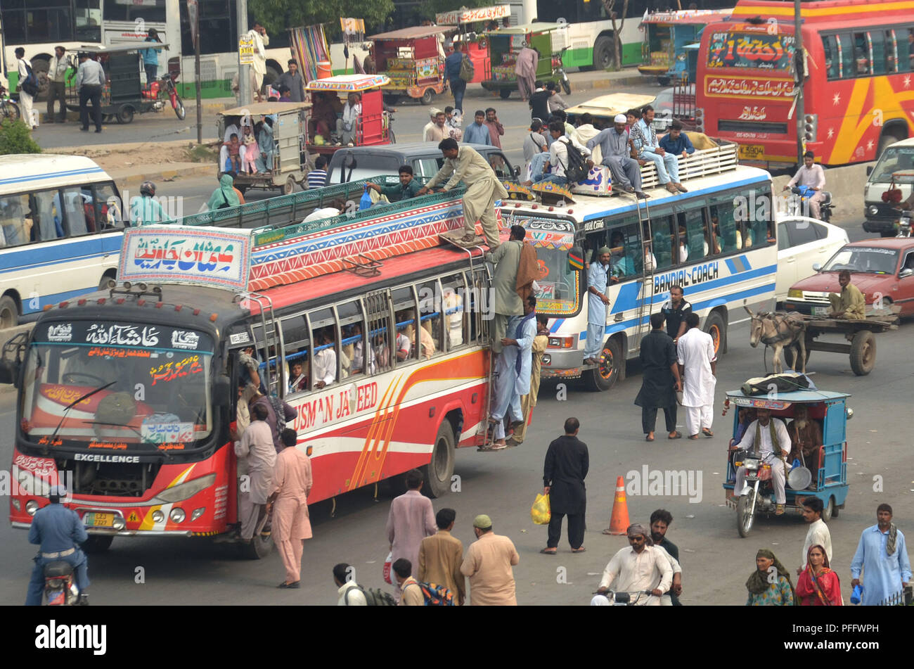 Pakistani passengers travel on a overcrowded bus to reach their ...