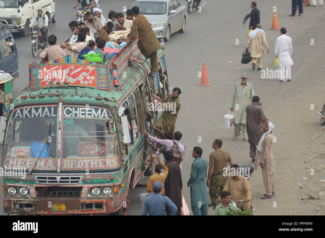 Pakistani passengers travel on a overcrowded bus to reach their ...