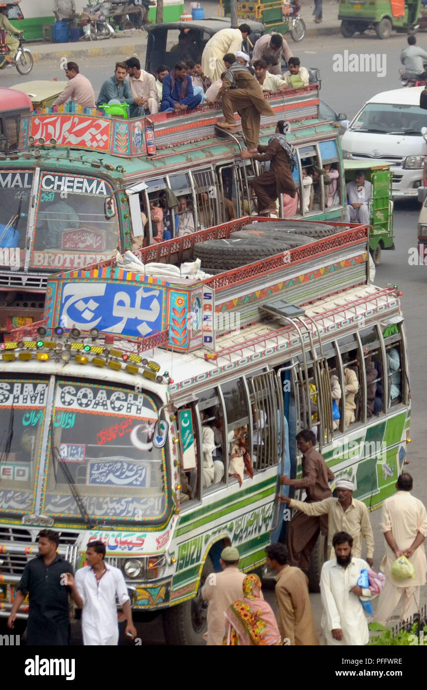 Pakistani passengers travel on a overcrowded bus to reach their ...