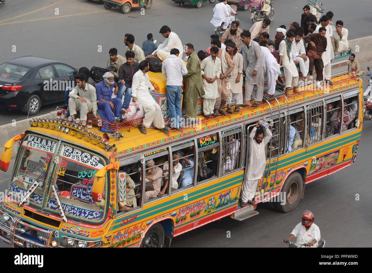 Pakistani passengers travel on a overcrowded bus to reach their ...