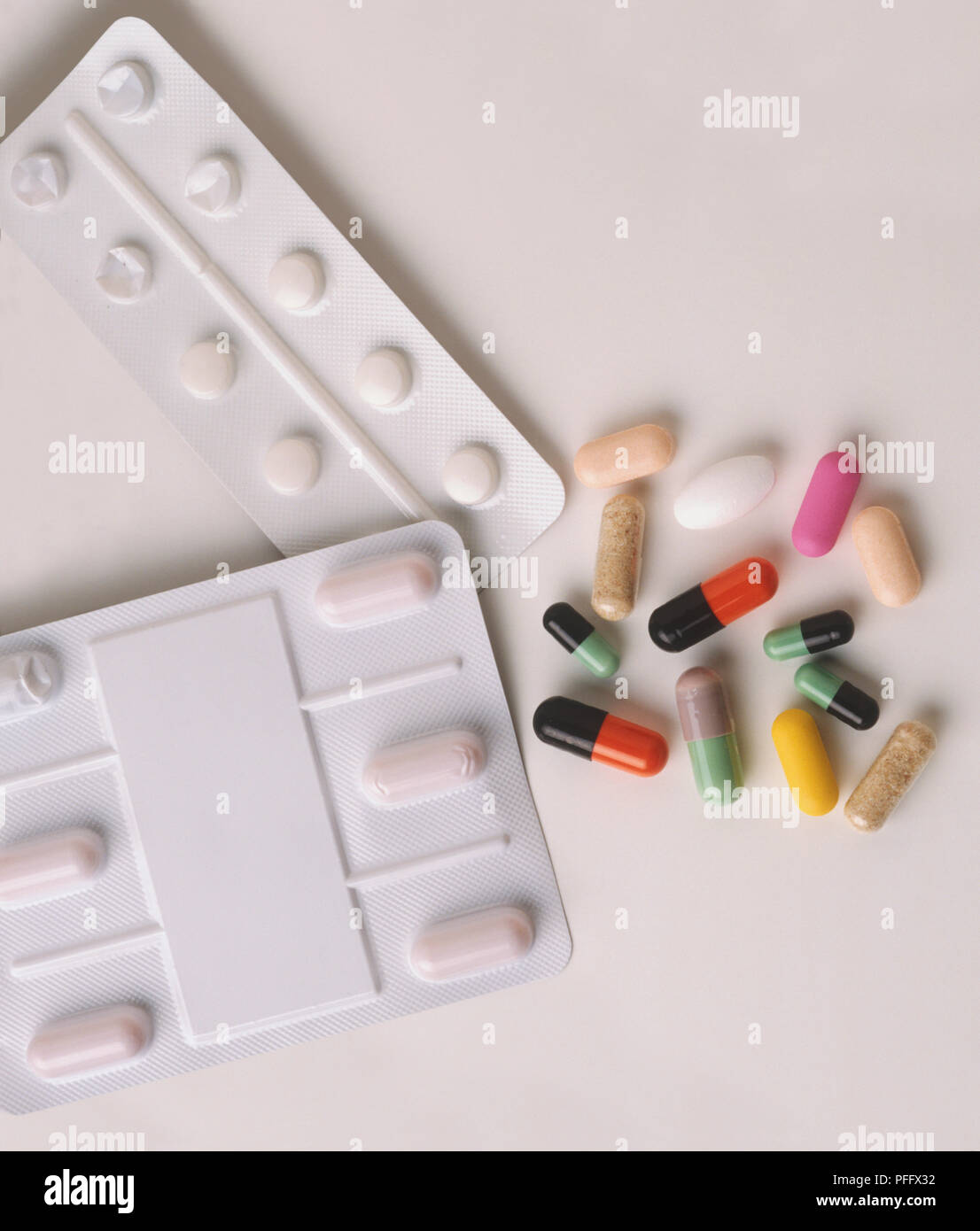 Colourful selection of capsules and tablets, loose and in blister packs ...