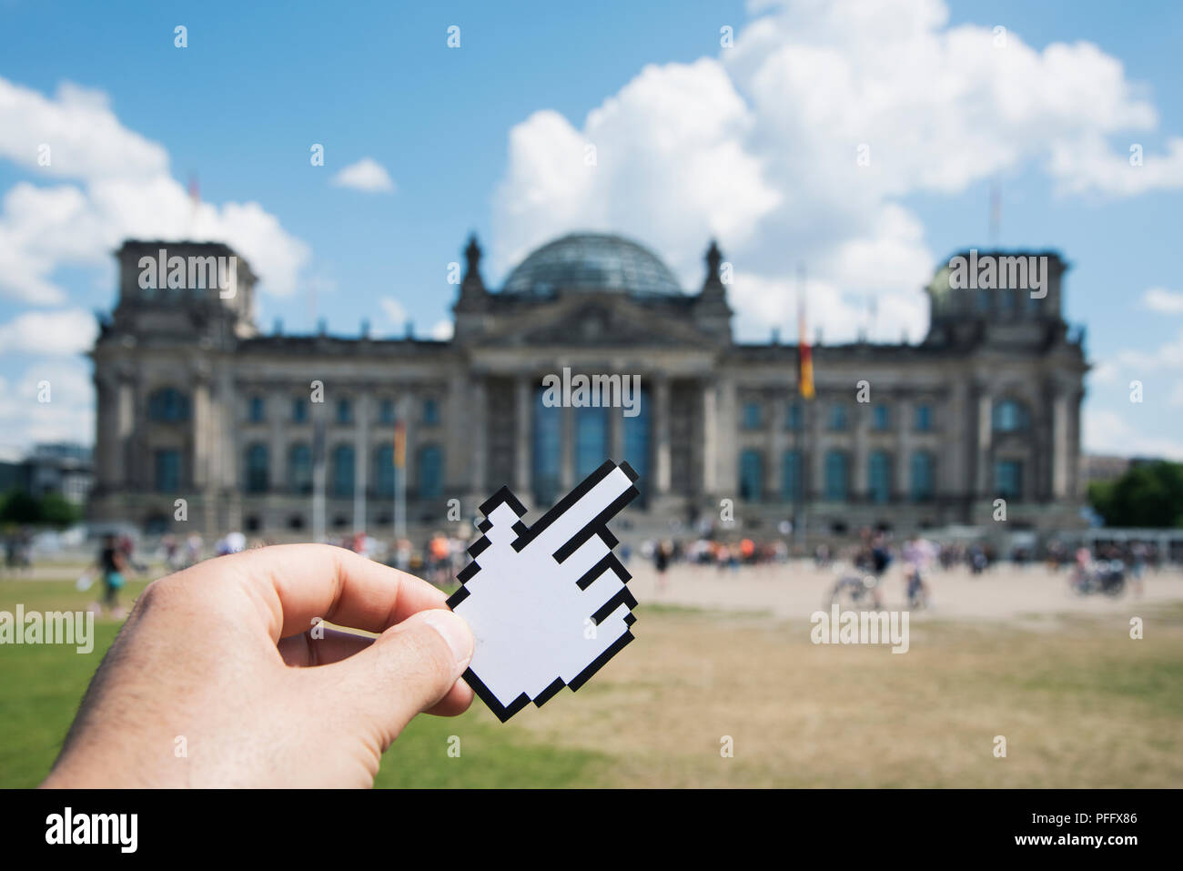 closeup of the hand of a young caucasian man pointing the Reichstag ...