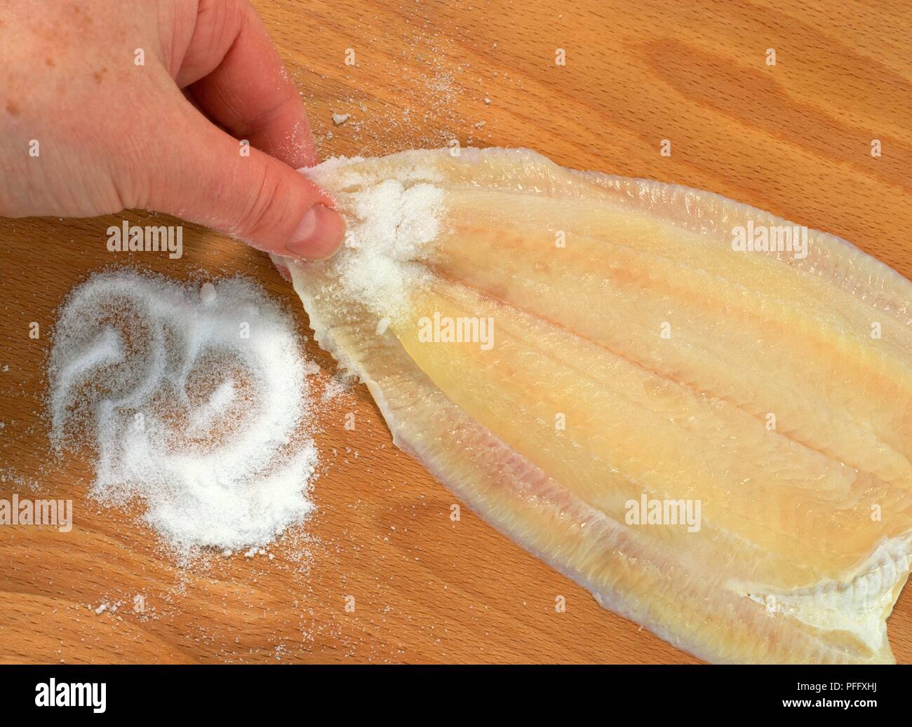 Using salt to get a firm grip on fish fillet, skin-side down, before ...