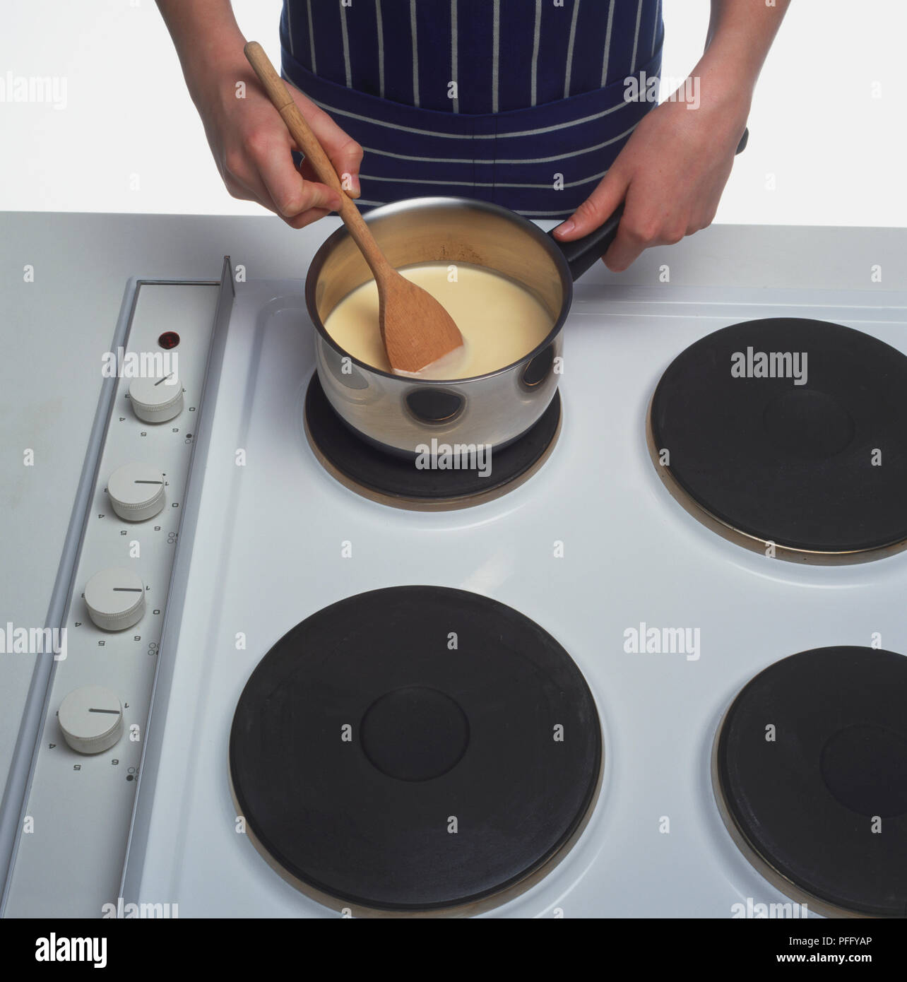 Stirring custard mixture saucepan, high angle view Stock Photo - Alamy
