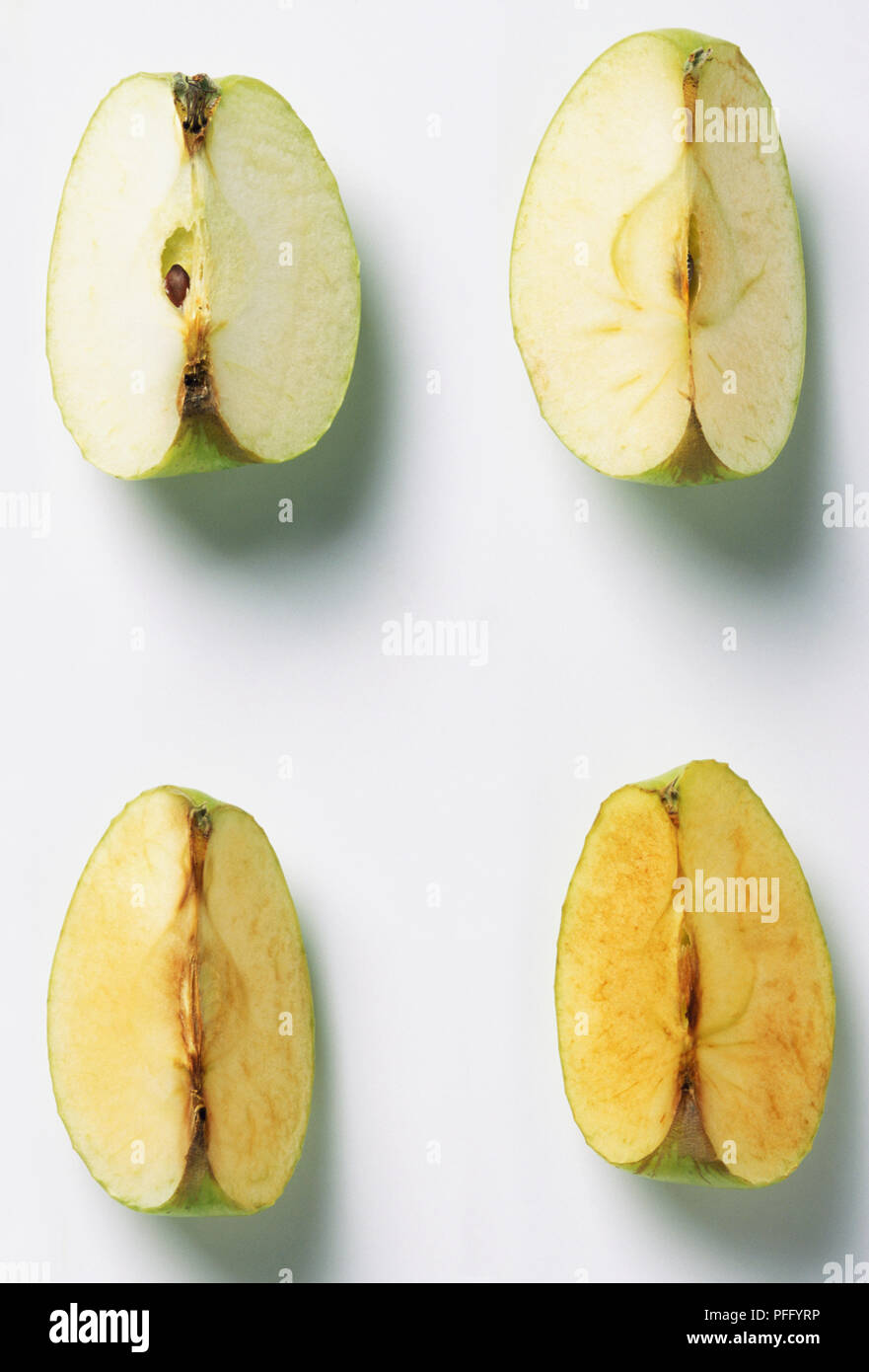 Four apple quarters, two of them turned brown Stock Photo - Alamy