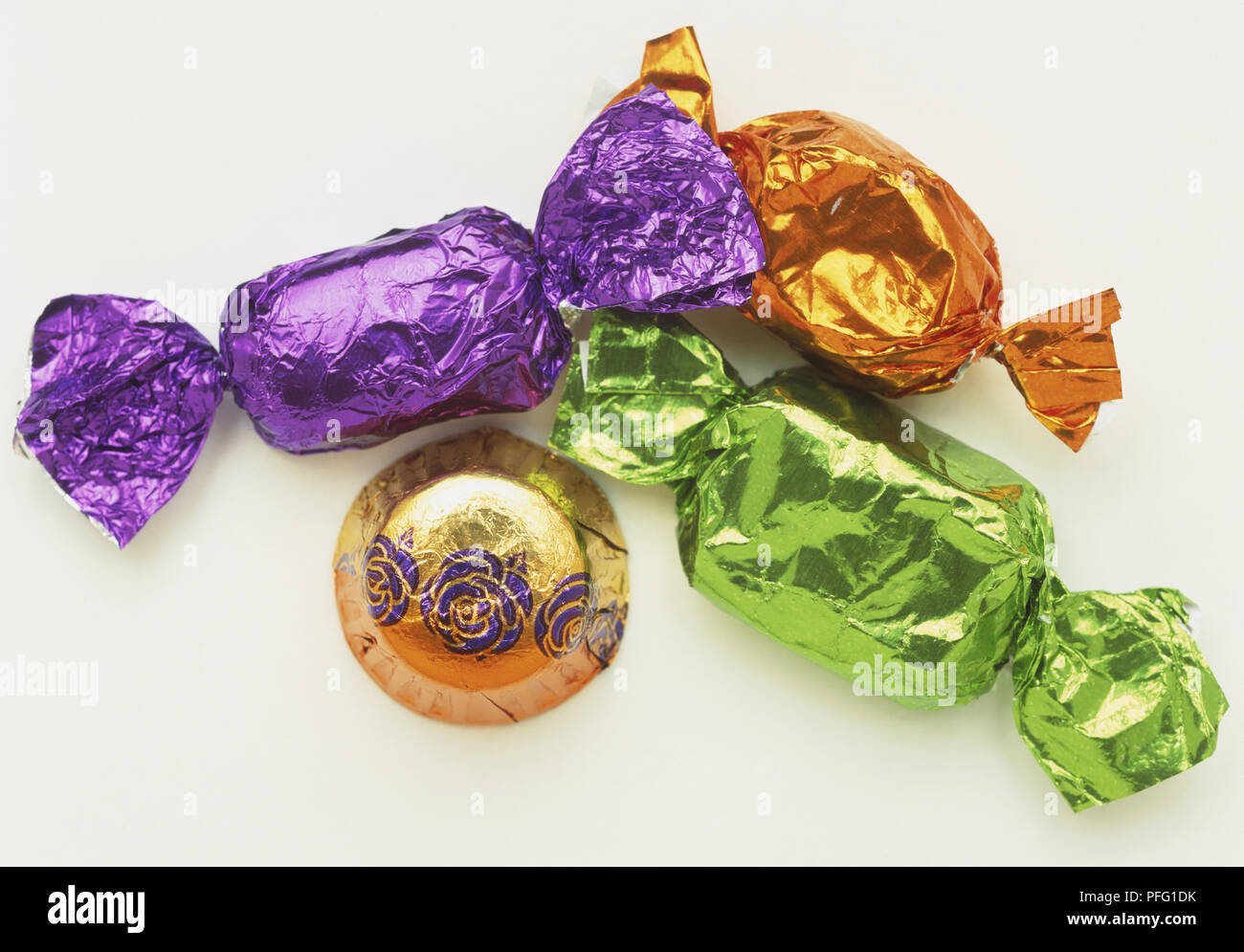 Four wrapped sweets, close up Stock Photo - Alamy