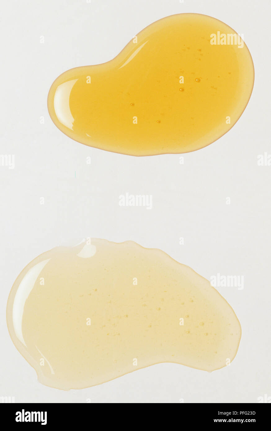 A droplet of yellow oil beside a droplet of colourless oil Stock Photo ...