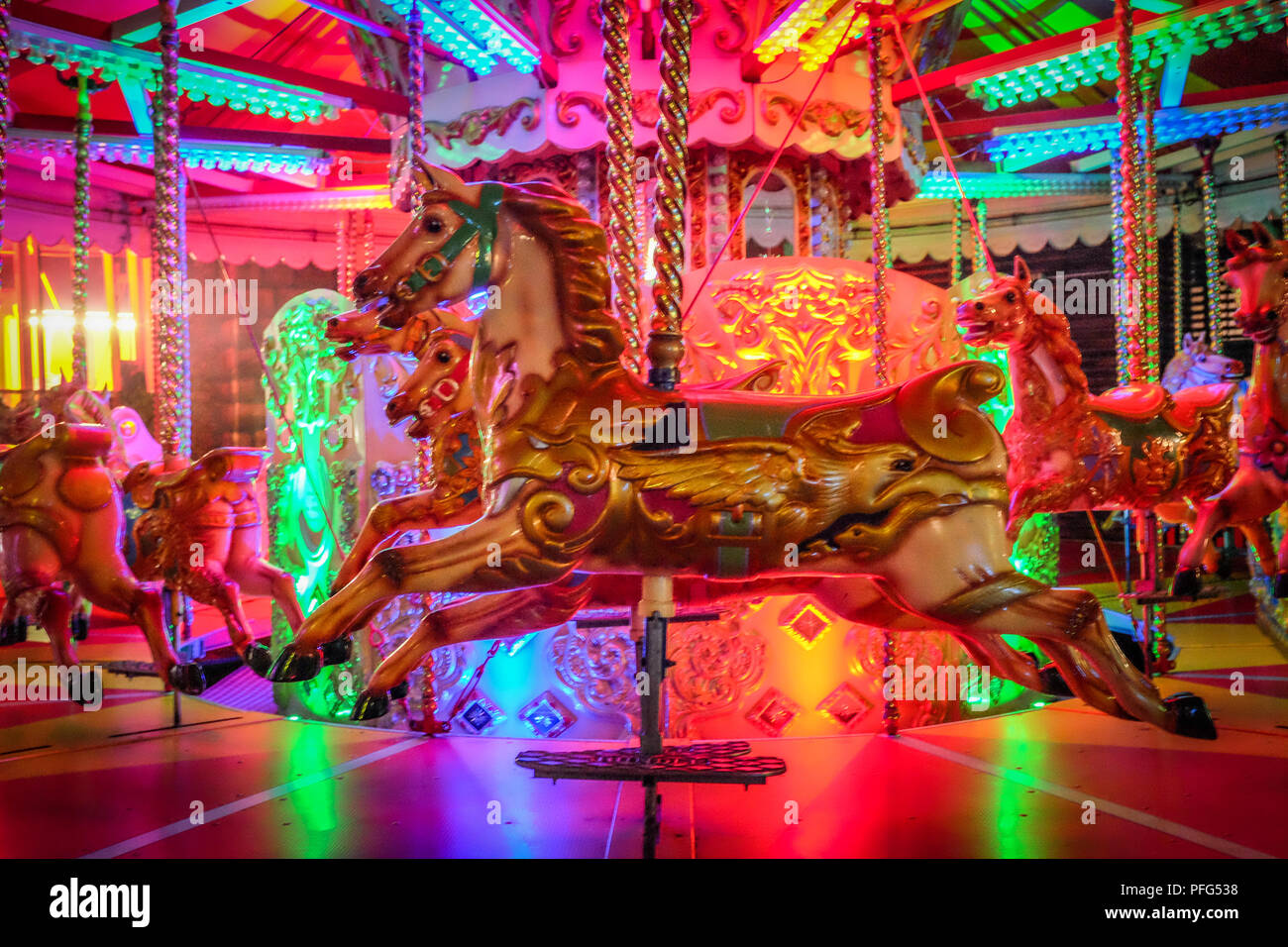 Colourful lights and horse on merry go round Stock Photo - Alamy