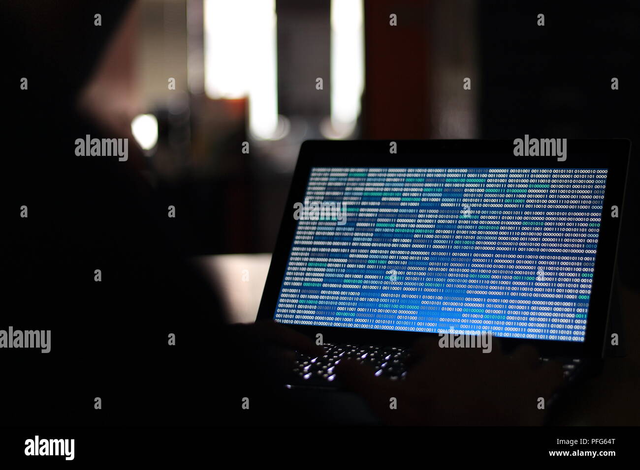 Computer Hacker silhouette typing on computer in a dark room. Working ...