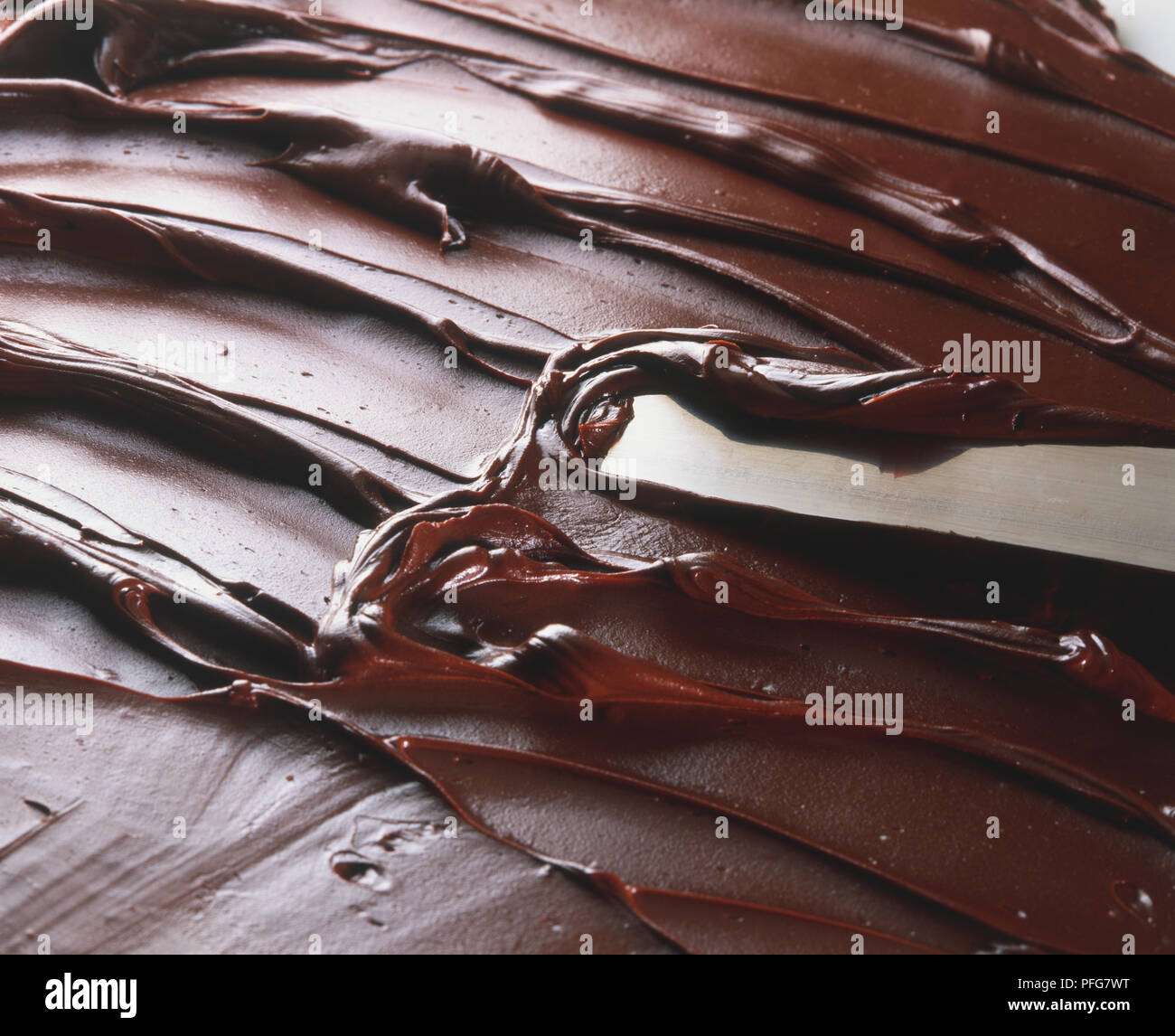 Palette knife makes patterns in melted chocolate Stock Photo - Alamy